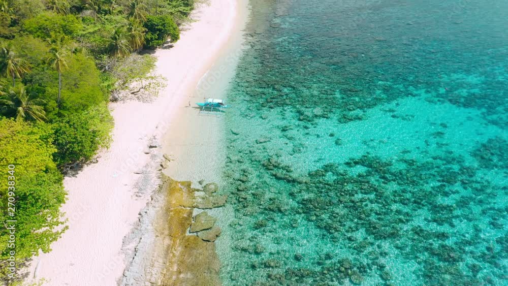 Aerial view. First tourist banca boat on tropical sandy beach ...