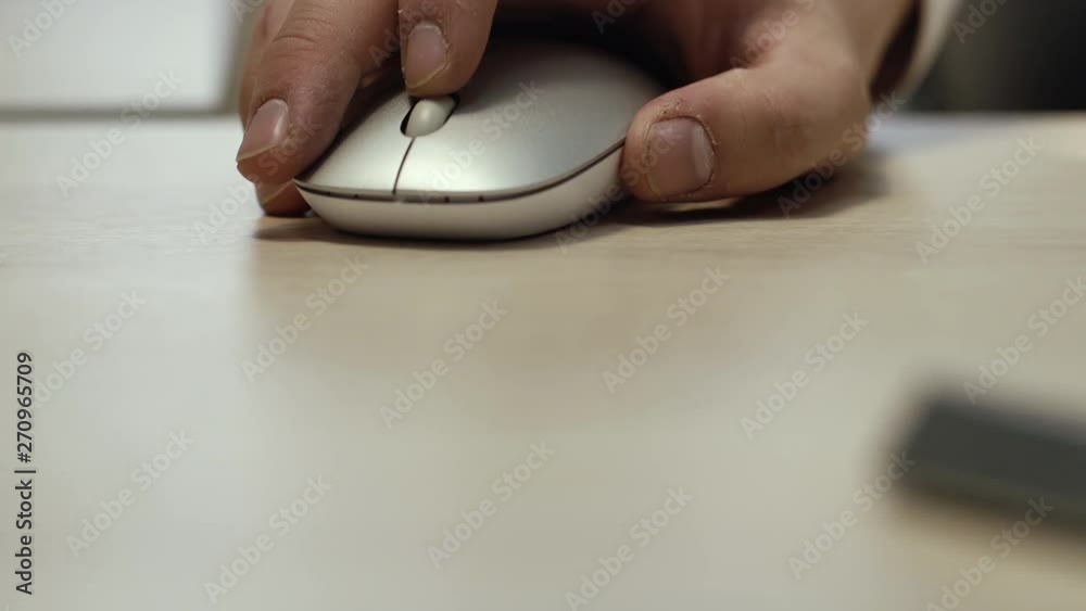 Close-up of a man hand uses white wireless mouse. Closeup male hand ...