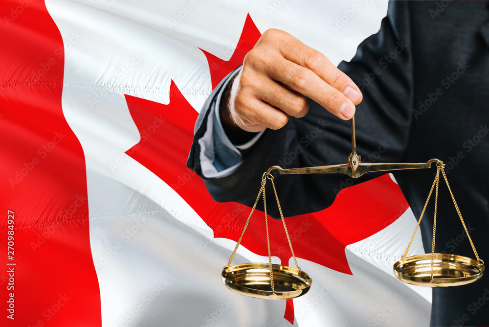 Canadian Judge is holding golden scales of justice with Canada waving ...