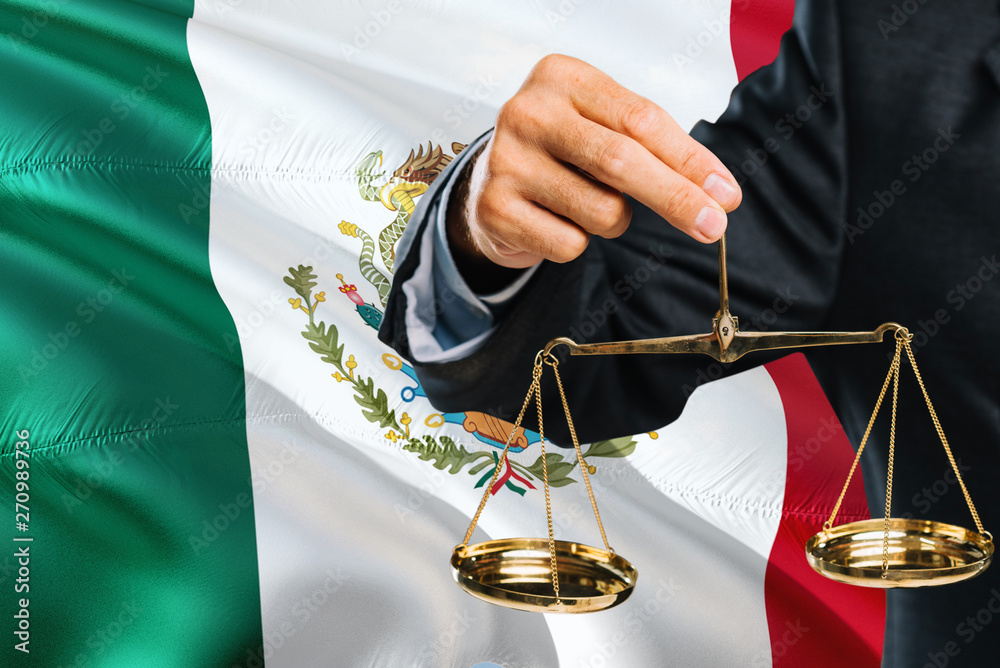 Mexican Judge is holding golden scales of justice with Mexico waving ...