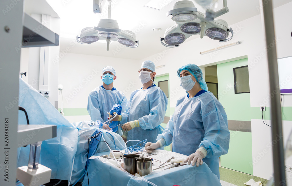 Arthroscope surgery. Orthopedic surgeons in teamwork in the operating ...