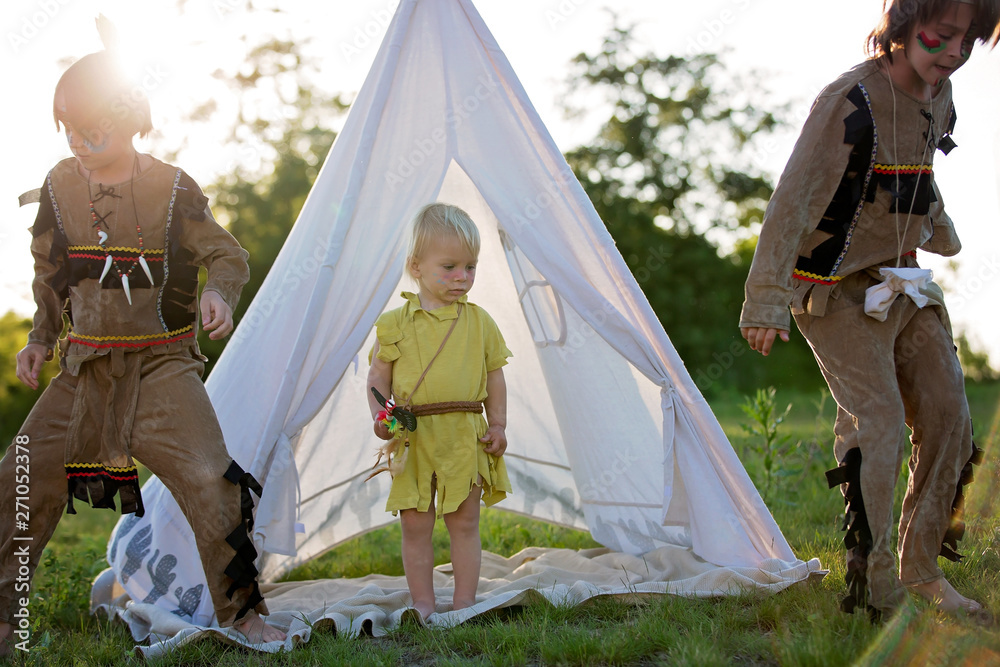 Cute portrait of native american boys with costumes, playing outdoor in ...