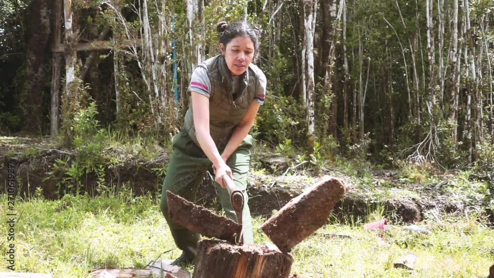 Woman chopping logs on the forest with a huge ax. Slow motion Stock ...