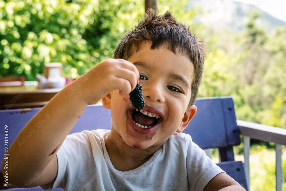 Kid eating mulberry Stock Photo | Adobe Stock