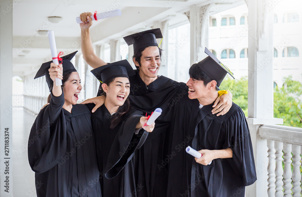 Young asian man and woman graduates holding certificate standing in ...