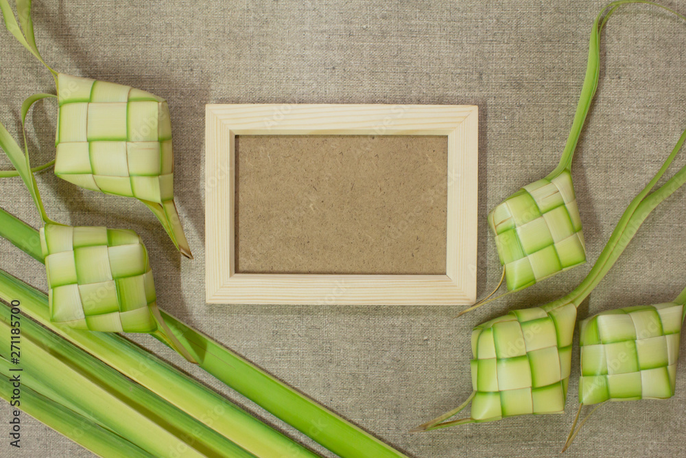 Ketupat (rice dumpling) with wooden frame on jute texture background ...
