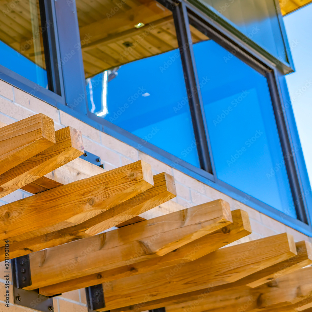 Square Building with decorative woods extending horizontally from the ...