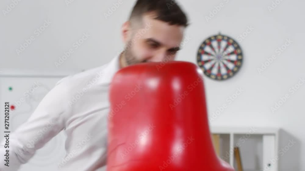 Chest-up shot of young company employee, wearing white shirt and red ...