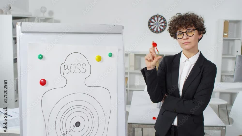 Dollying portrait shot of female company employee with curly hair ...