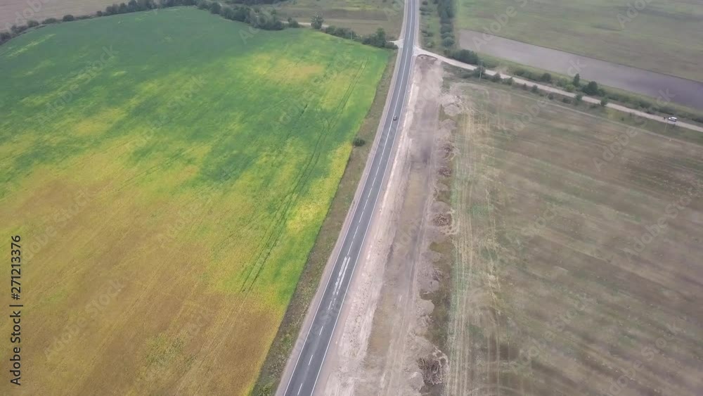 Aerial view of the road in the middle of a field from a drone, Ukraine ...