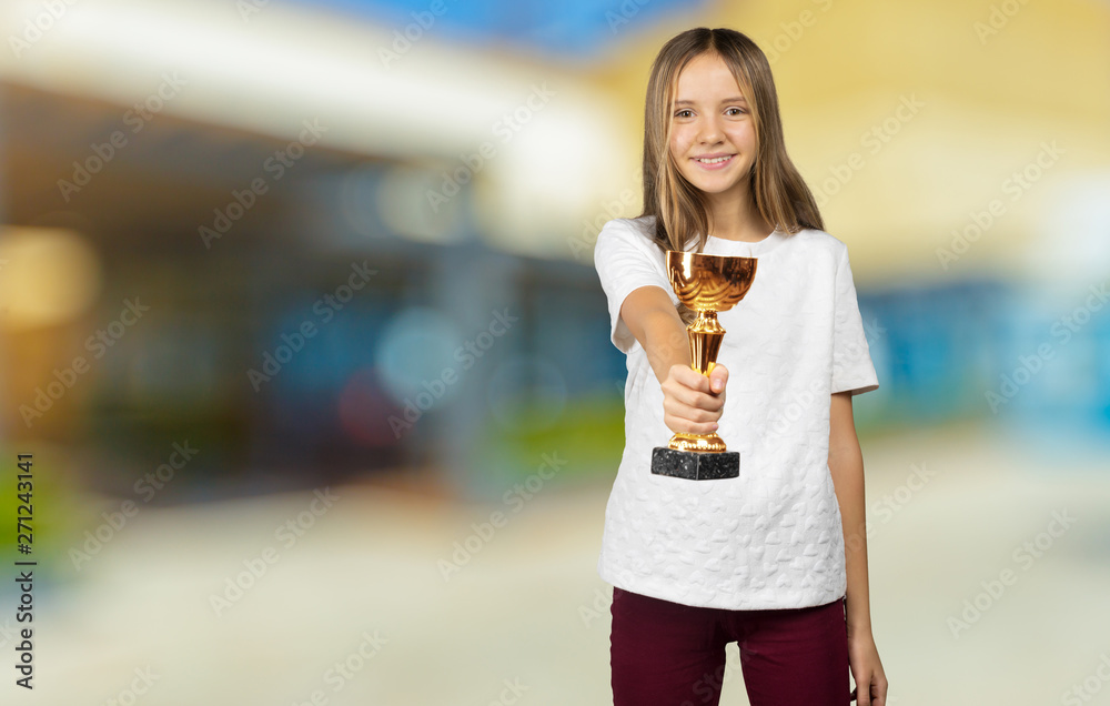 Happy winner. Portrait of beautiful Teen Girl Student with gold trophy ...