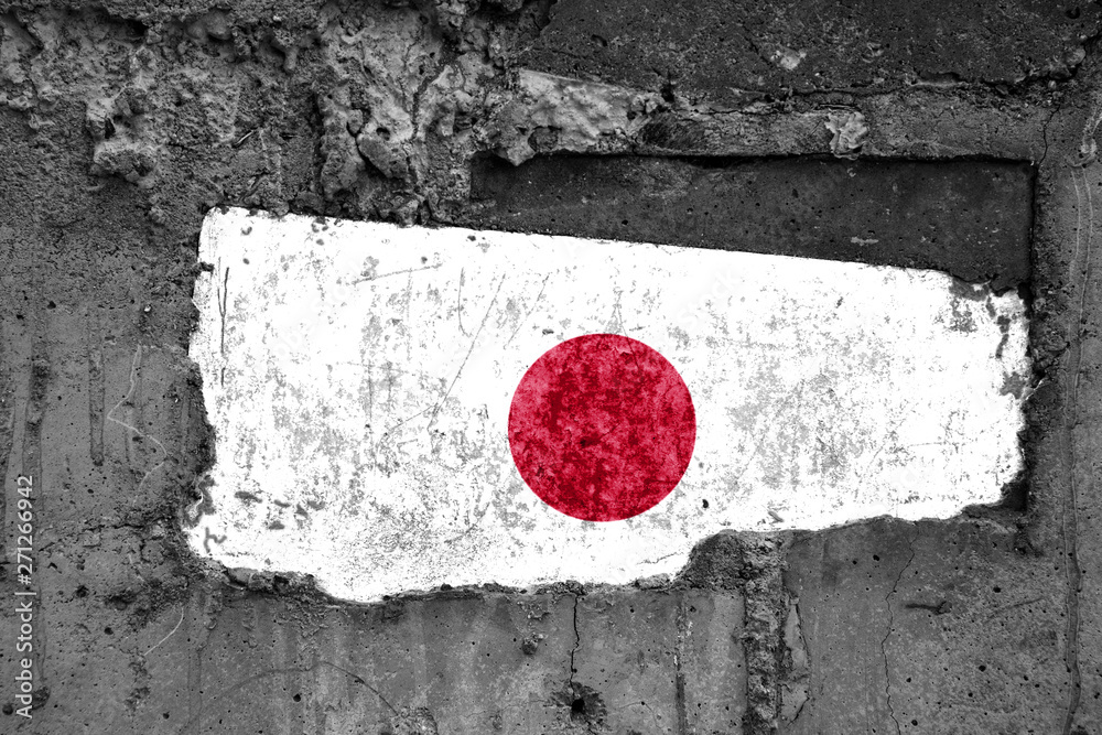The flag of Japan on a dirty wooden surface, built into a concrete base ...