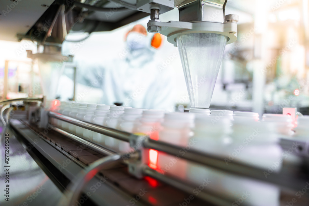 Transfer medicine bottles on the conveyor belt in the pharmaceutical ...