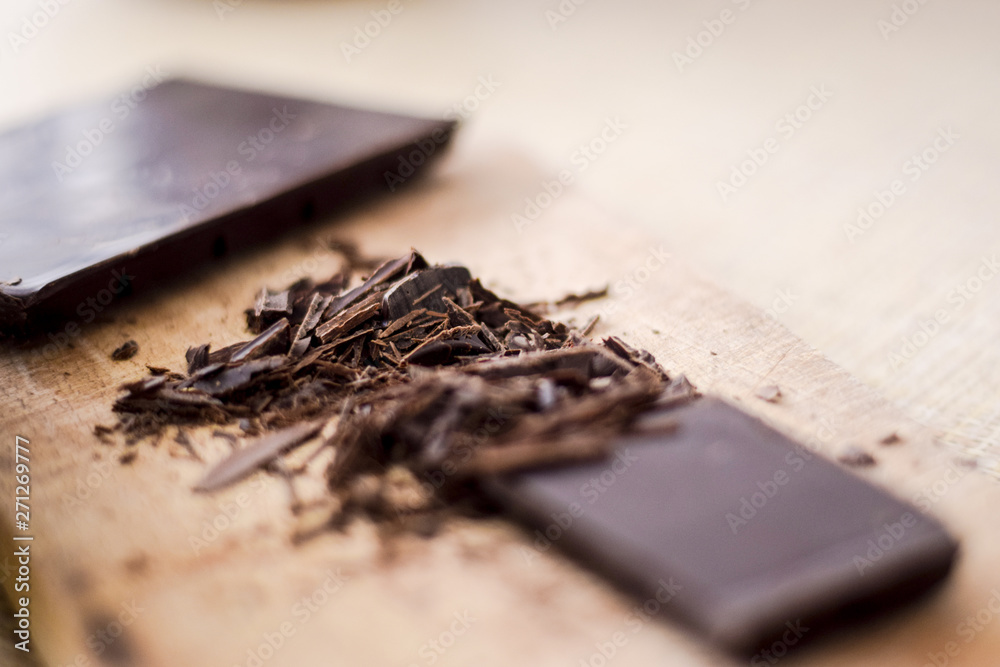 Cut chocolate pieces on the wooden background Stock Photo | Adobe Stock