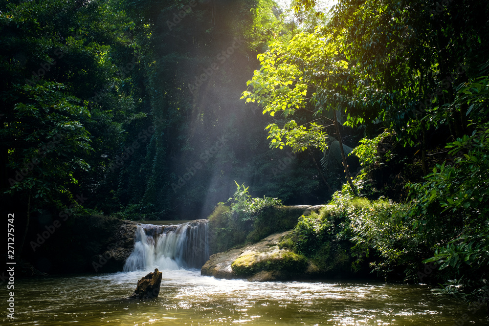 Mini waterfall and sunset sunny beams, travel destinations background ...