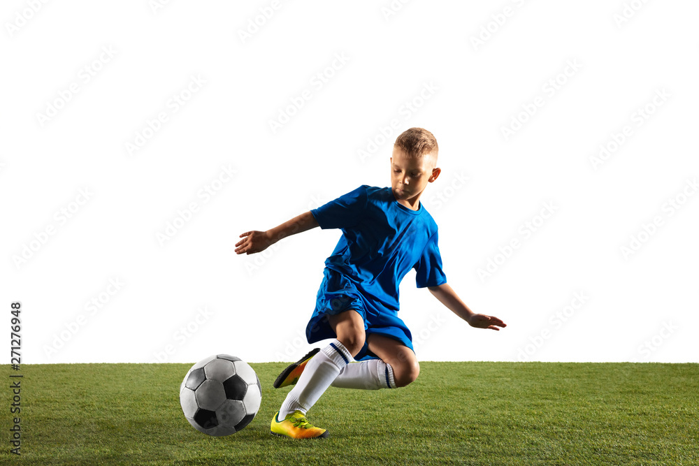 Young boy as a soccer or football player in sportwear making a feint or ...