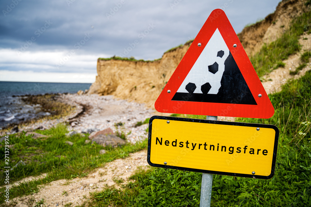 Falling rocks warning sign at danish coastline Stock Photo | Adobe Stock