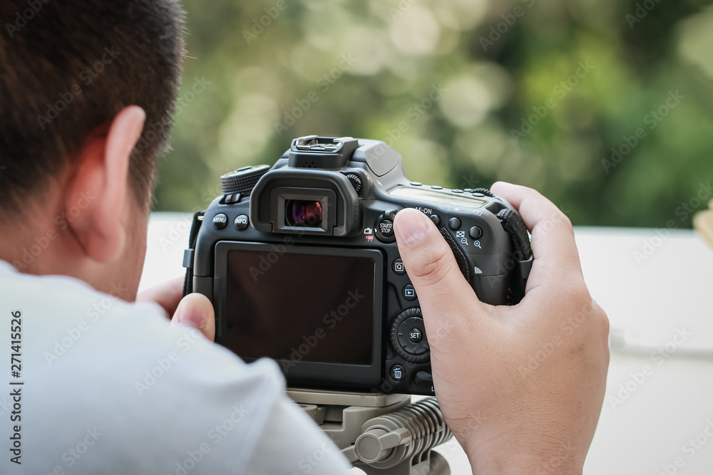 Professional Young Asian photographer working camera and setting to ...