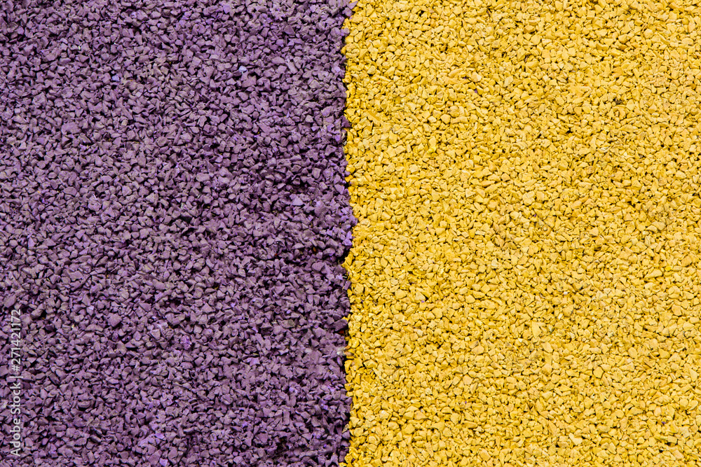 Protective yellow-purple rubber crumb coating. The texture is a safe ...
