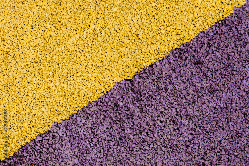 Protective yellow-purple rubber crumb coating. The texture is a safe ...