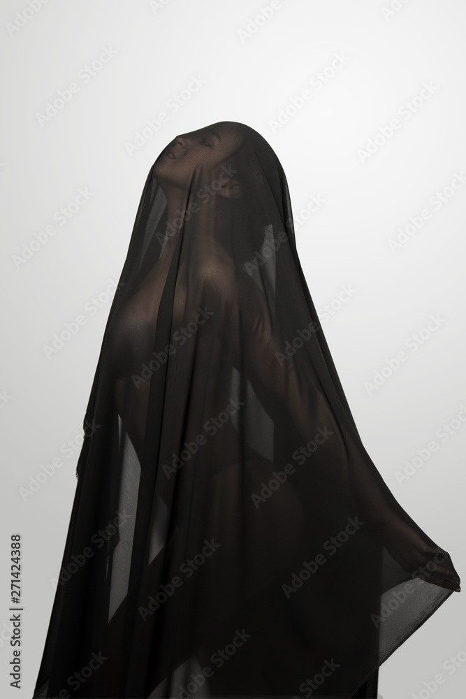 Girl in a black transparent veil on the face. Conceptual portrait in ...