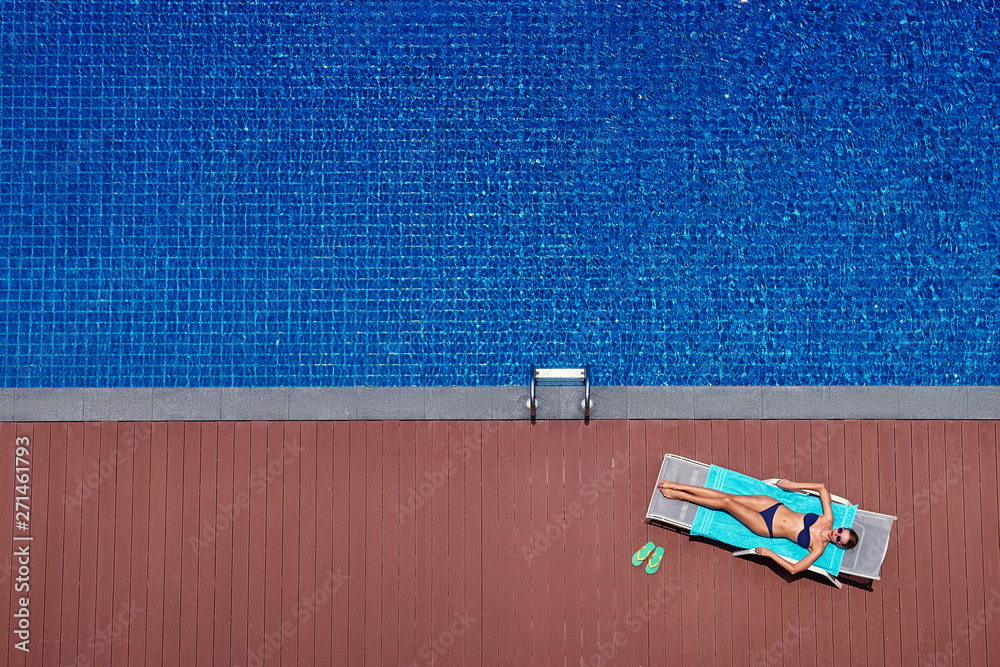 Enjoying suntan. Vacation concept. Top view of slim young woman in ...