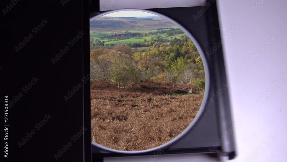 Vidéo Stock A disk ejecting from a DVD player with overlay of footage ...
