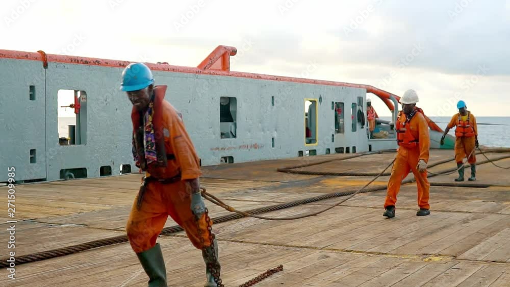 Anchor-handling Tug Supply AHTS vessel crew preparing vessel for static ...