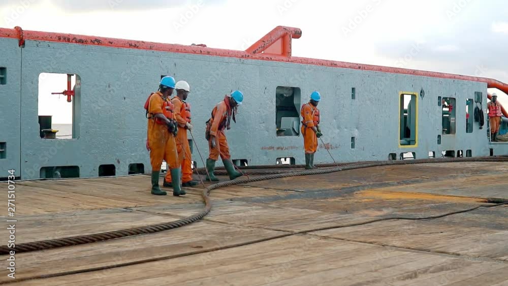 Anchor-handling Tug Supply AHTS vessel crew preparing vessel for static ...