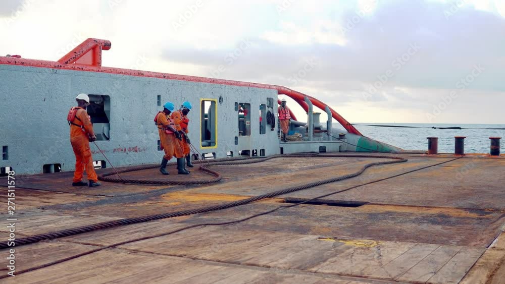 Anchor-handling Tug Supply AHTS vessel crew preparing vessel for static ...