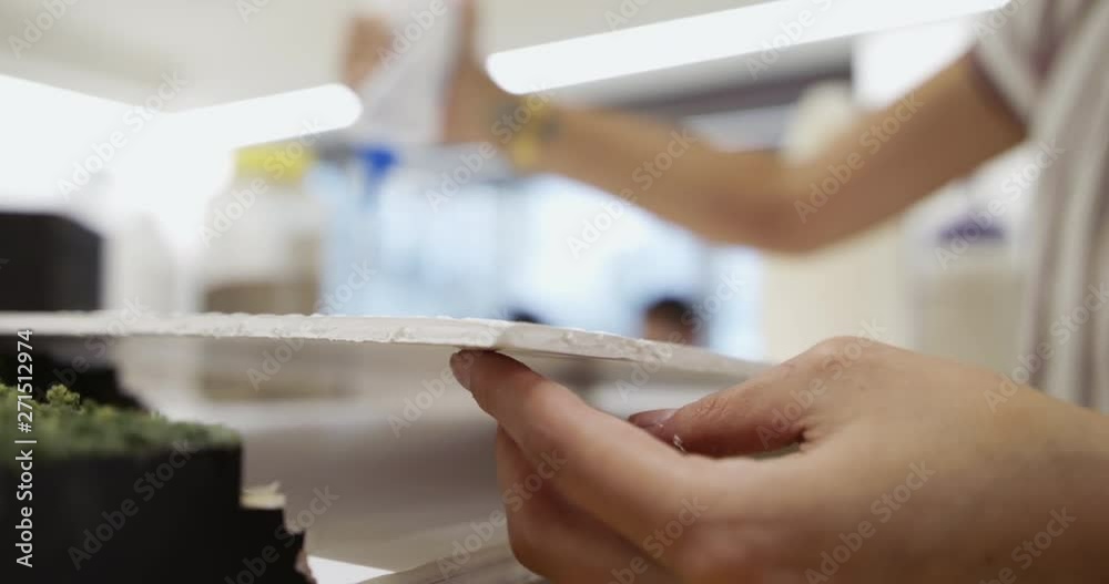 People at work in architecture design studio with plastic model and ...