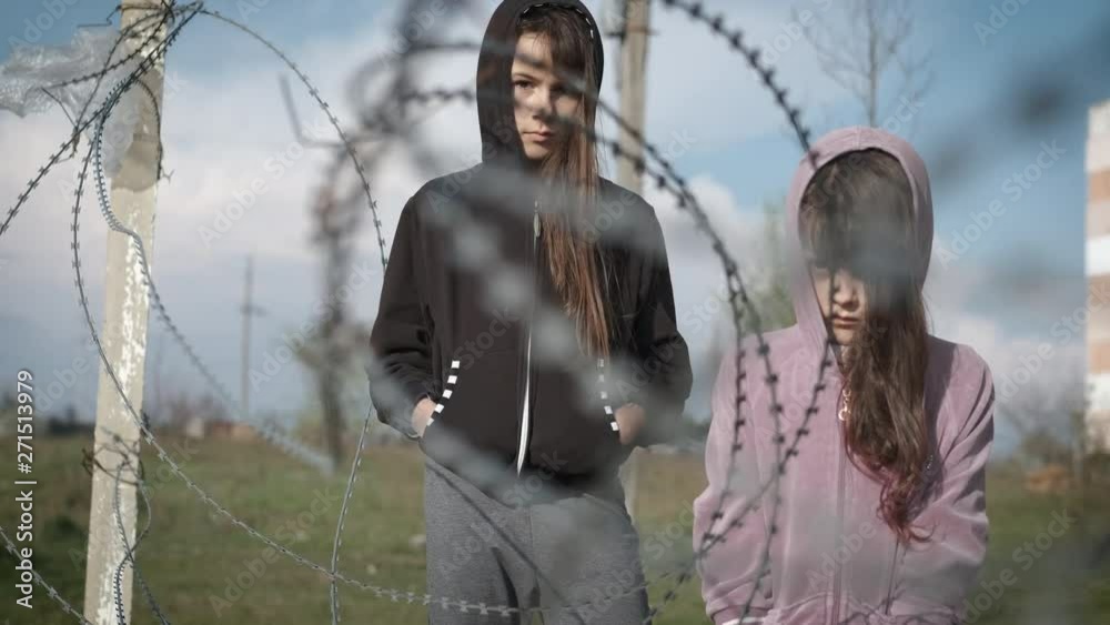 Children behind barbed wire. Sad children behind barbed wire. Children ...