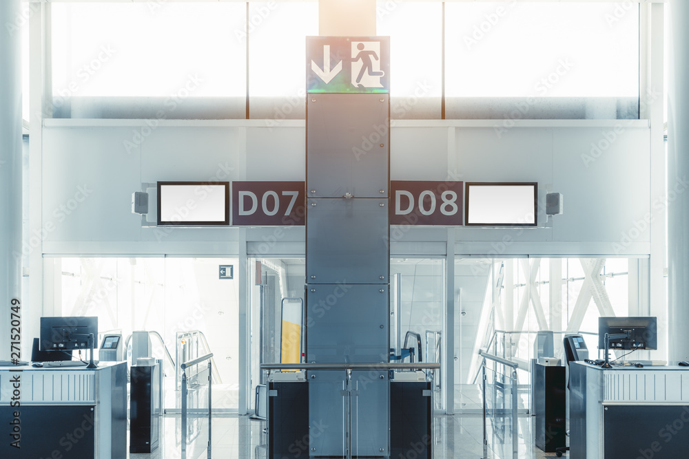 An empty gates of a modern airport terminal with computer monitors on ...