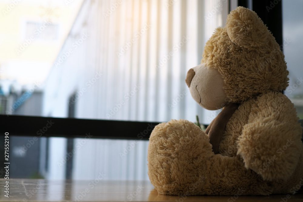 Child concept of sorrow. Teddy bear sitting leaning against the wall of ...