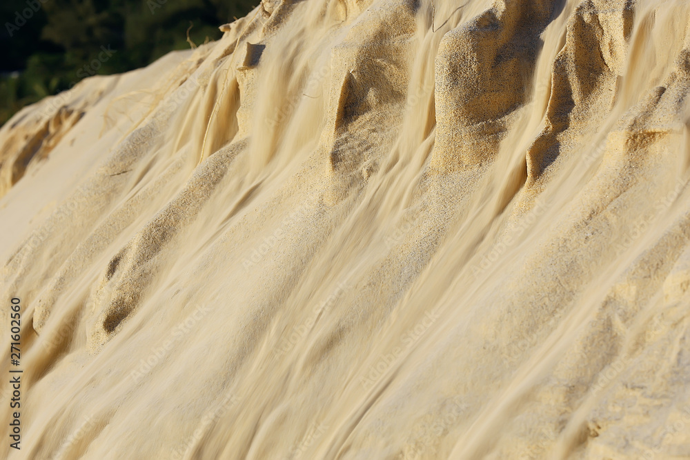 the texture of the sand is drowned by sand dunes / sand avalanche is ...