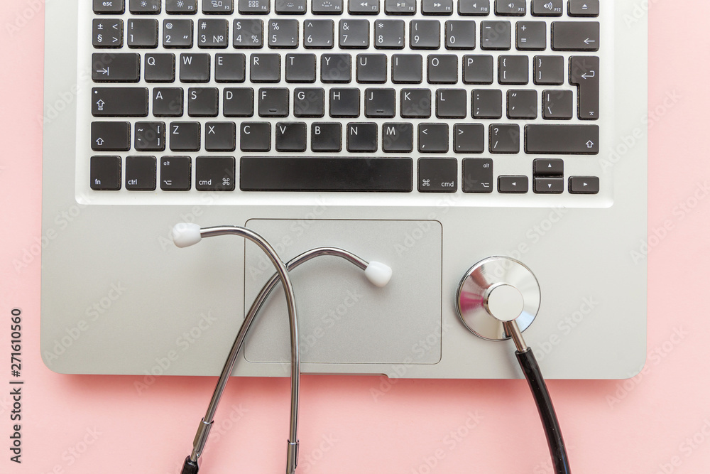 Stethoscope keyboard laptop computer isolated on pink background ...