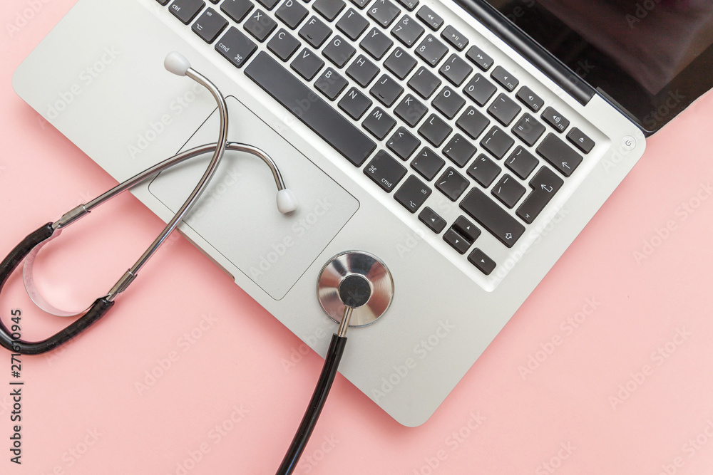 Stethoscope keyboard laptop computer isolated on pink background ...