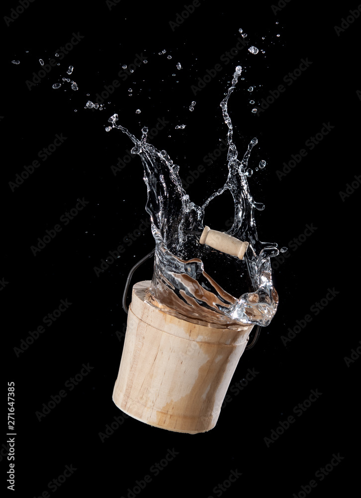 Wooden bucket with water splash or explosion flying in the air isolated ...