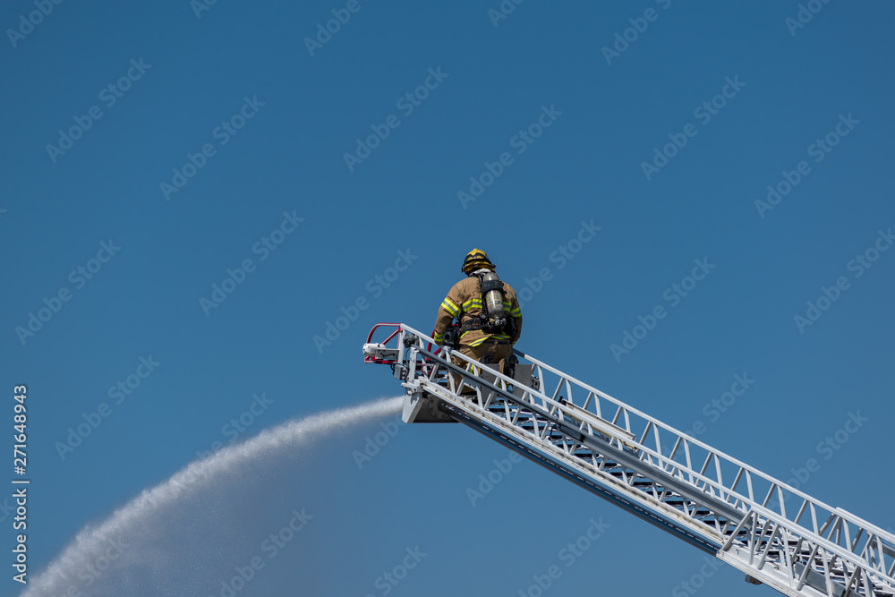 Firefighter on Ladder During a Structure Fire Stock Photo | Adobe Stock