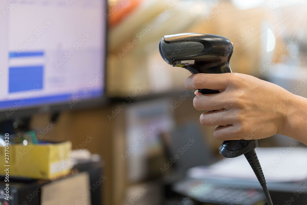 Close up barcode scanner in hand on blurred background,Inspection of ...