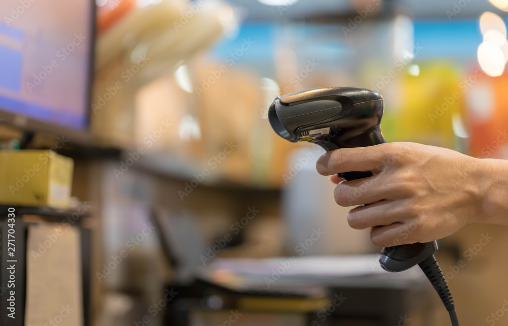 Close up barcode scanner in hand on blurred background,Inspection of ...
