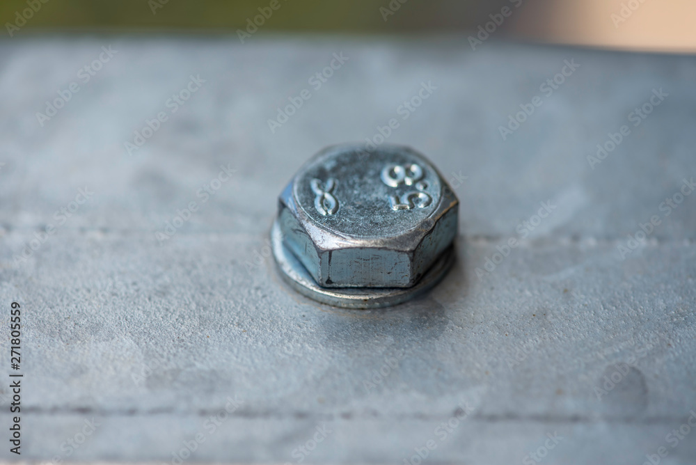 hat of a metal bolt twisted in a metal surface with a nut Stock Photo ...