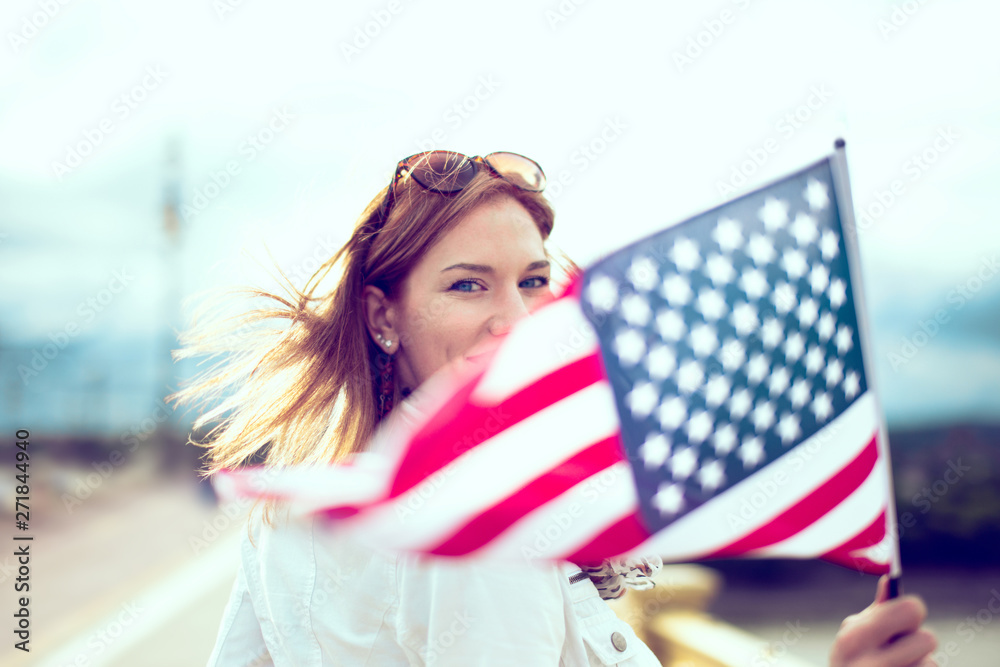Young patriot modern woman holding USA flag depth of field Stock Photo ...
