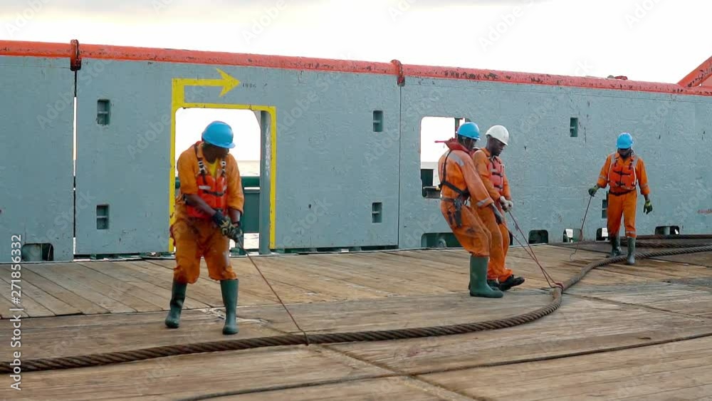 Anchor-handling Tug Supply AHTS vessel crew preparing vessel for static ...