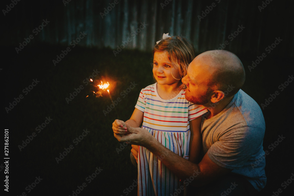 Father and Daughter doing firework sparklers together Stock Photo ...
