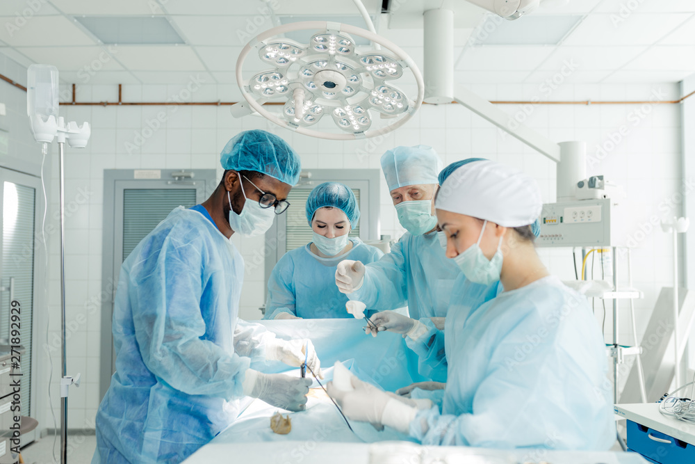 doctors opening the abdomen in the operating room. exploratory laparotomy, appendectomy, and ...
