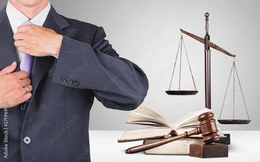 Lawyer standing with crossed arms, Scales of Justice on the background ...