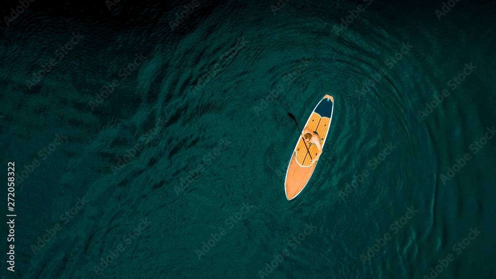 Strong man on blue SUP in water Stock Photo | Adobe Stock