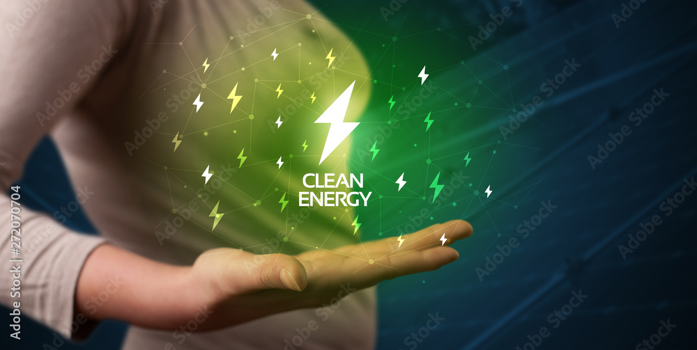 Hand in suit holding lightning bolt on his hand, green environment ...