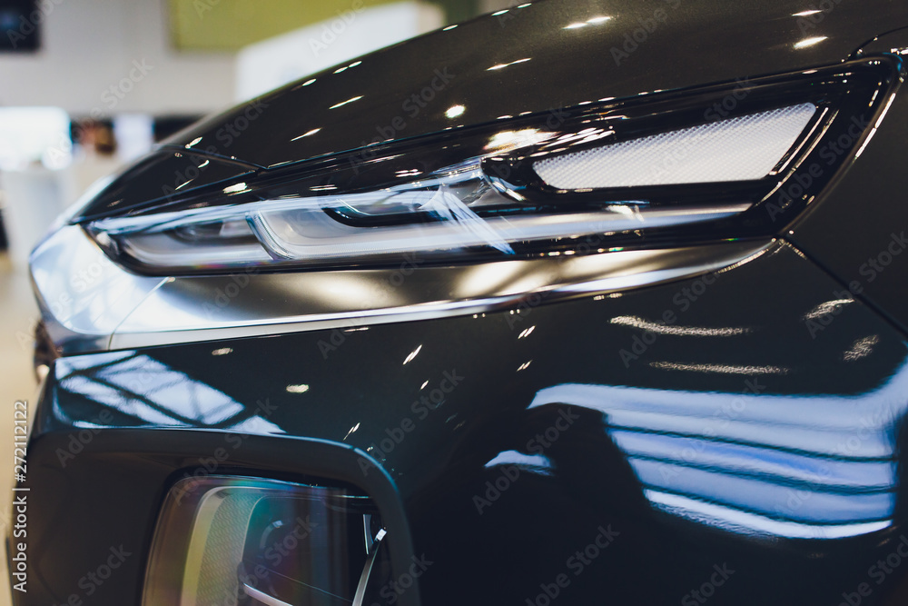 Close up of headlight detail of modern luxury car with projector lens ...